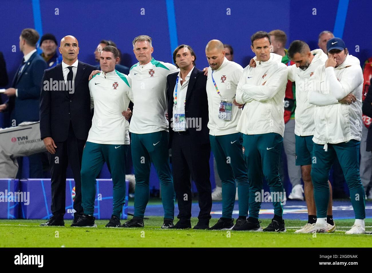 Portugal manager Roberto Martinez (left) and stsaff look on during a ...
