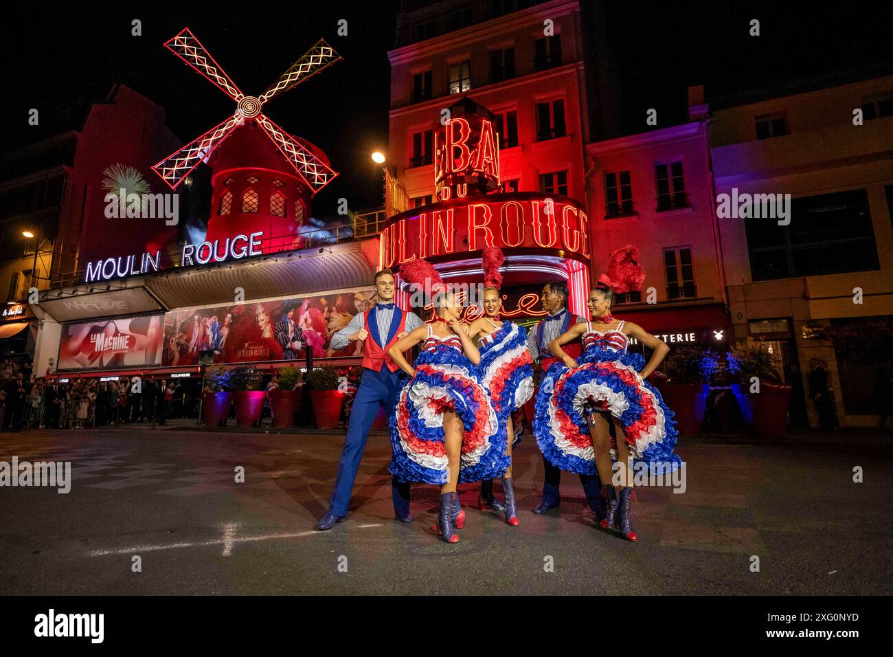 Dancers perform in front of the Moulin Rouge cabaret during the ...