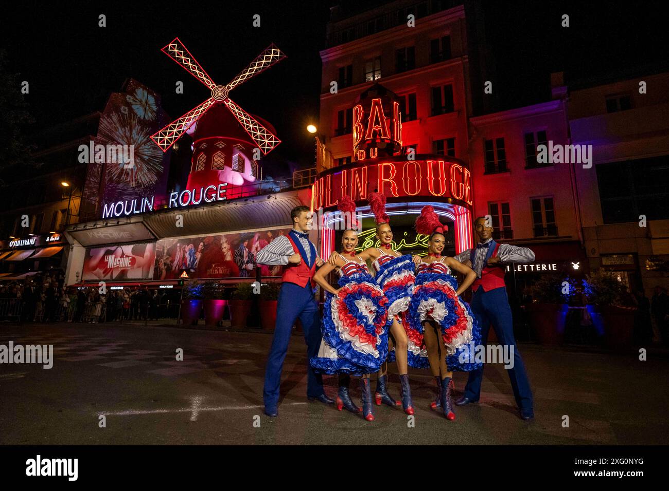 Dancers perform in front of the Moulin Rouge cabaret during the ...