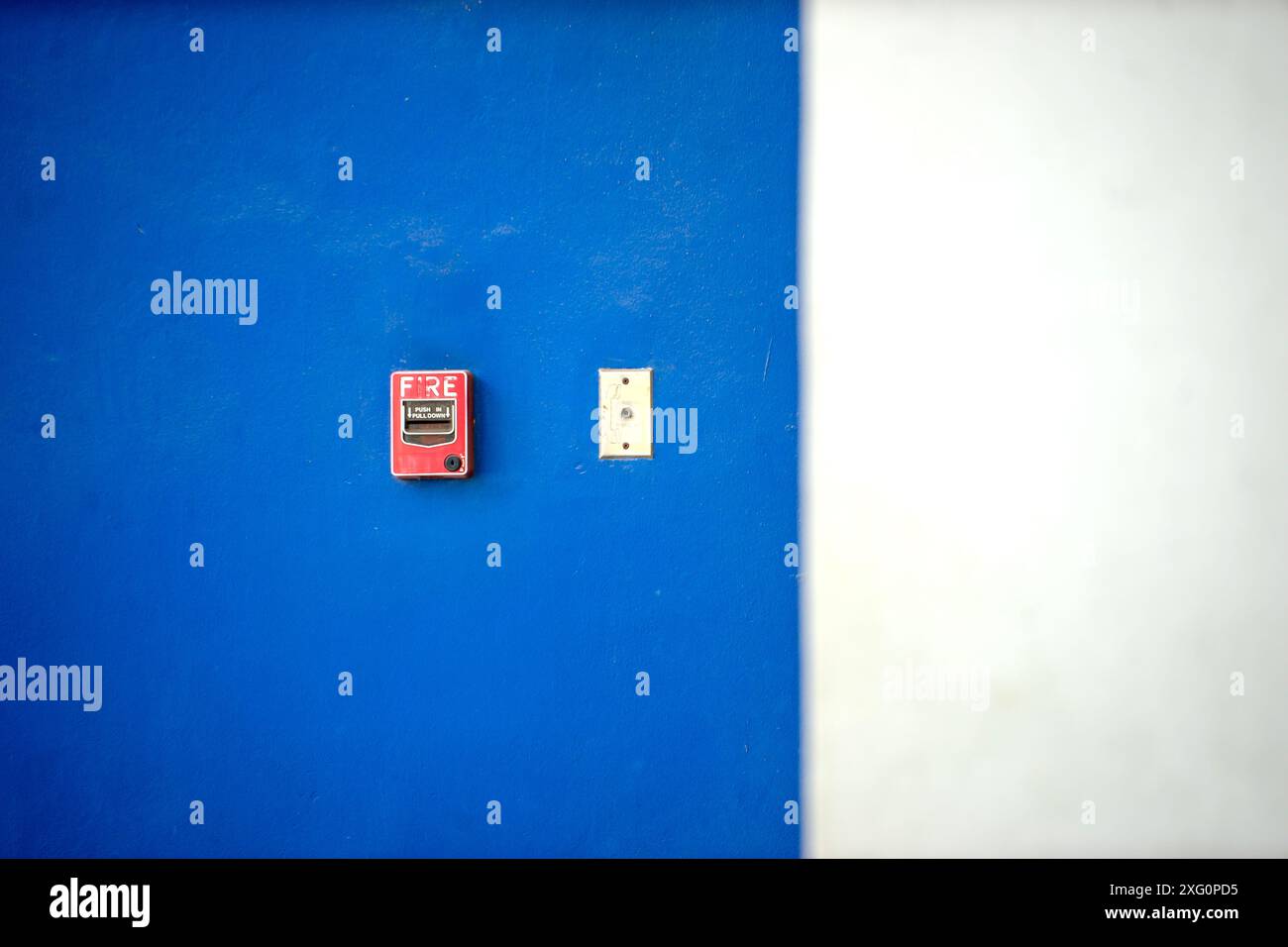 Fire bell pull sign in supermarket Stock Photo - Alamy