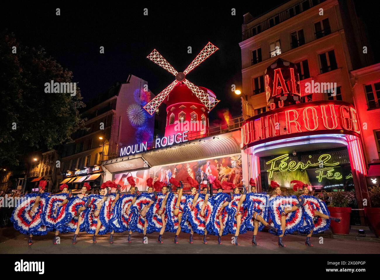 Dancers perform in front of the Moulin Rouge cabaret during the ...