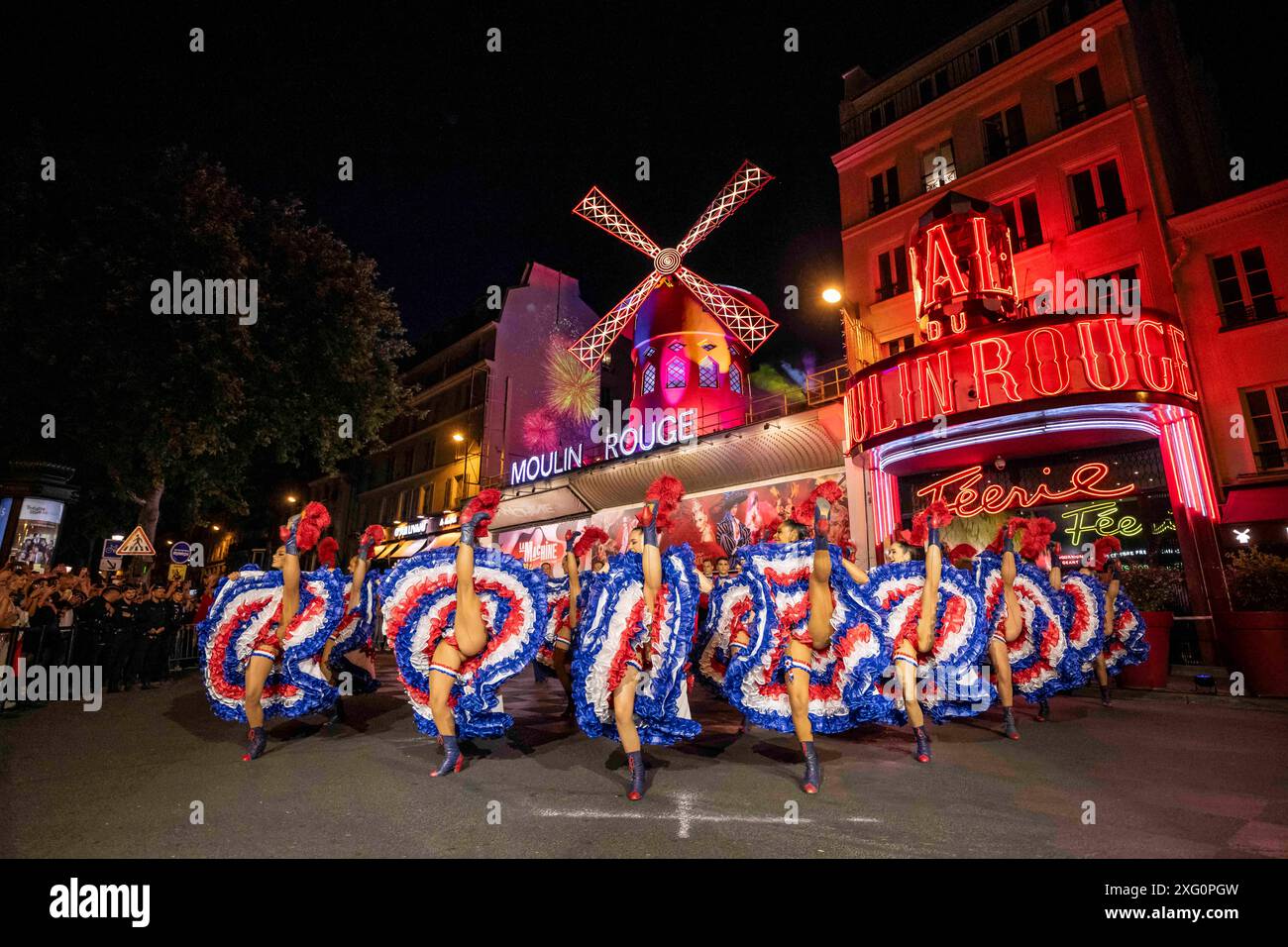 Dancers perform in front of the Moulin Rouge cabaret during the ...