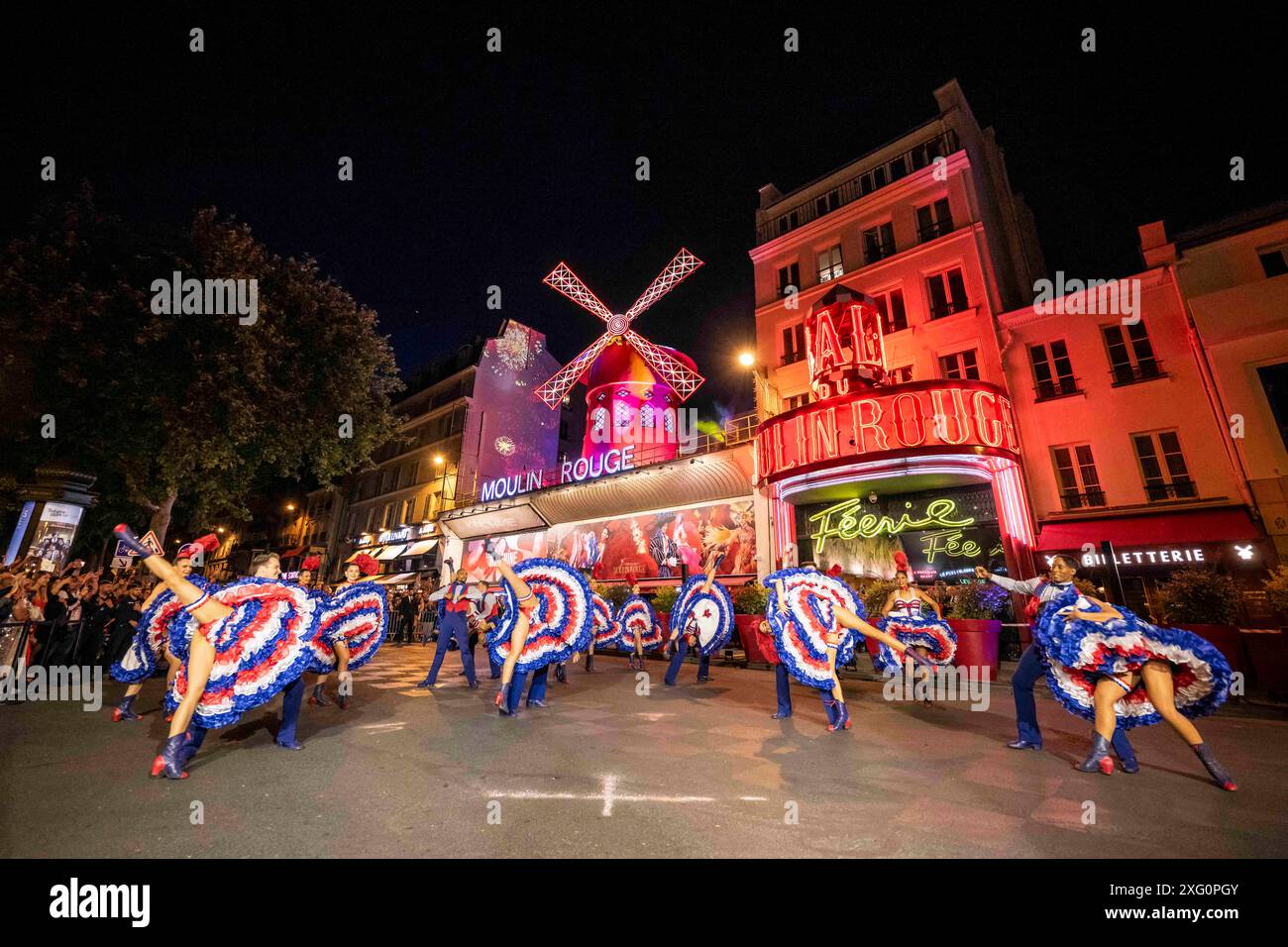 Dancers perform in front of the Moulin Rouge cabaret during the ...