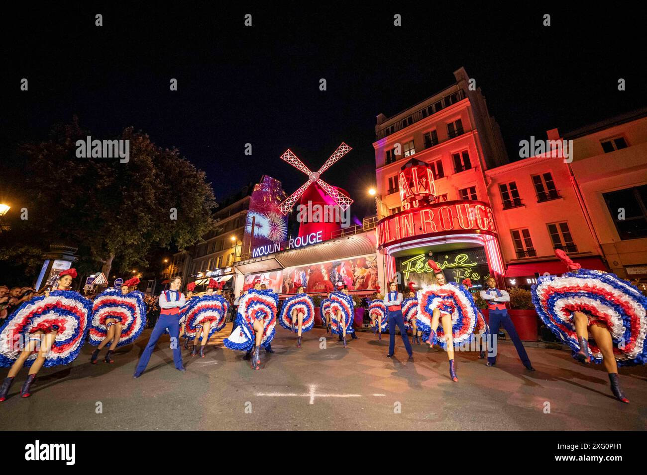 Dancers perform in front of the Moulin Rouge cabaret during the ...