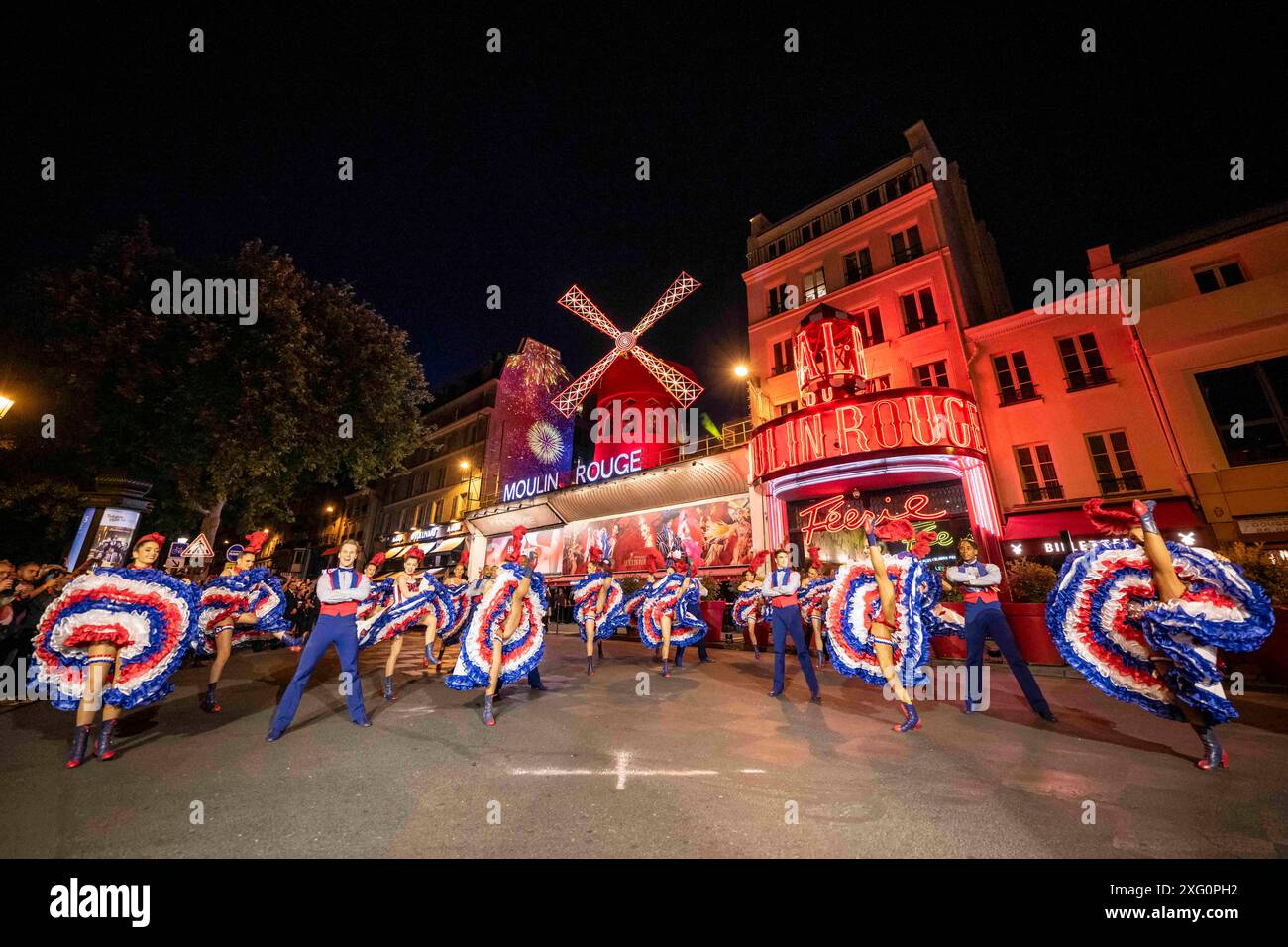 Dancers perform in front of the Moulin Rouge cabaret during the ...