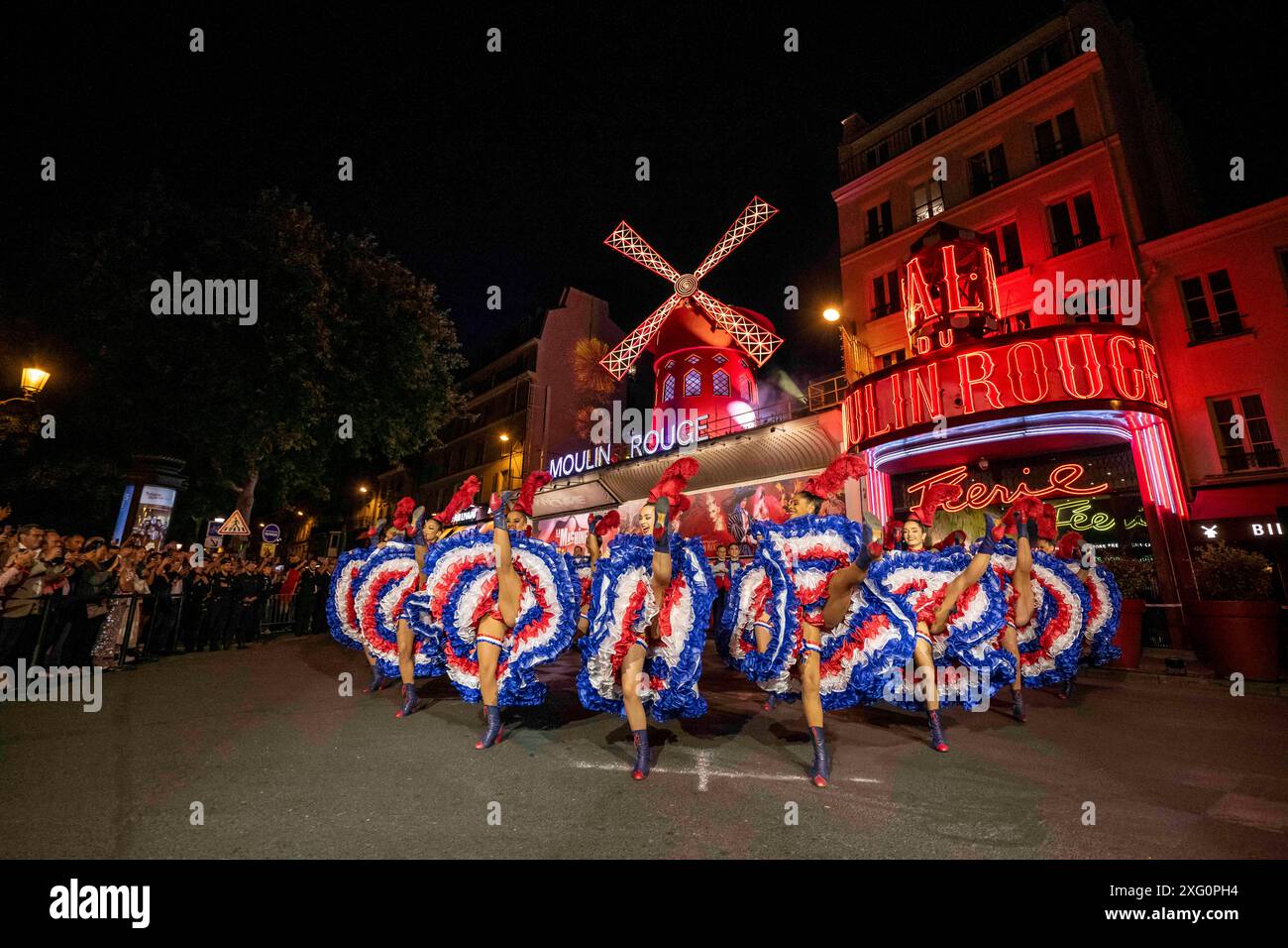 Dancers perform in front of the Moulin Rouge cabaret during the ...