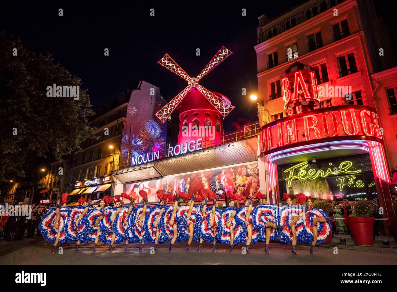 Dancers perform in front of the Moulin Rouge cabaret during the ...