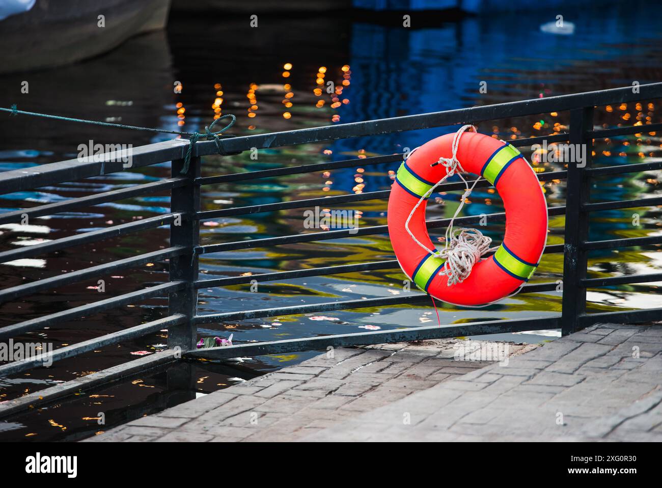 Life-saving rubber ring installed in the water area Stock Photo - Alamy