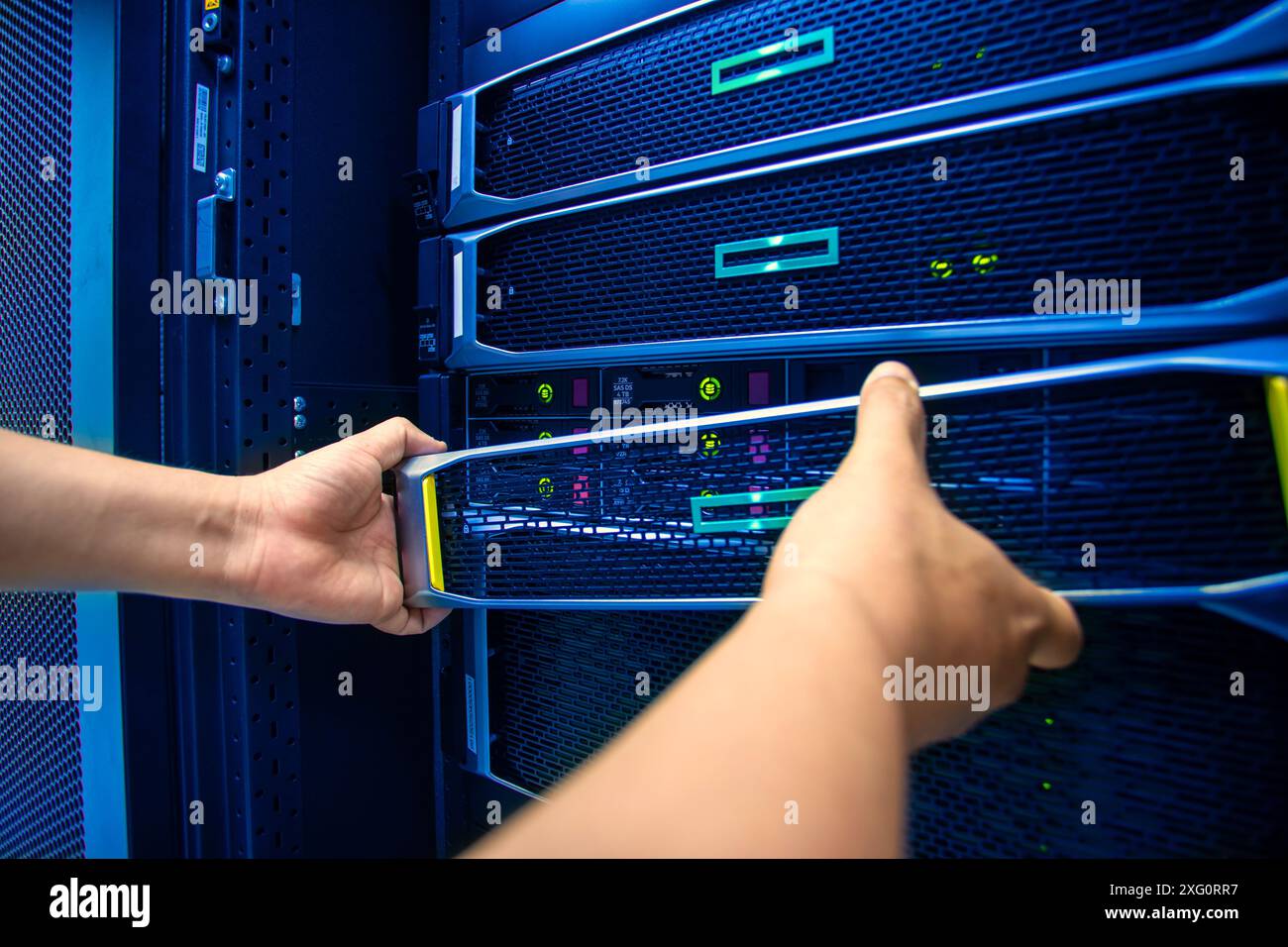 Man fixing server in data center room Stock Photo - Alamy