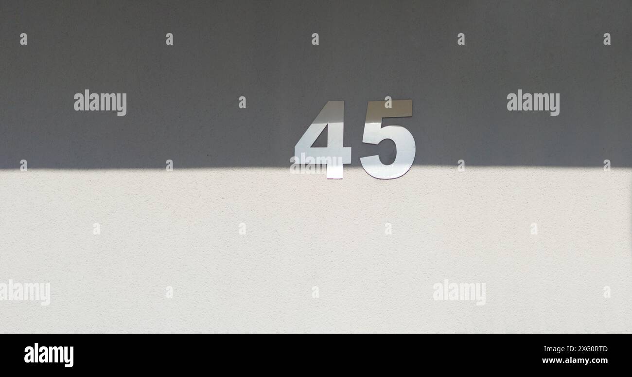 House number 45. Silver over grey wall Stock Photo - Alamy