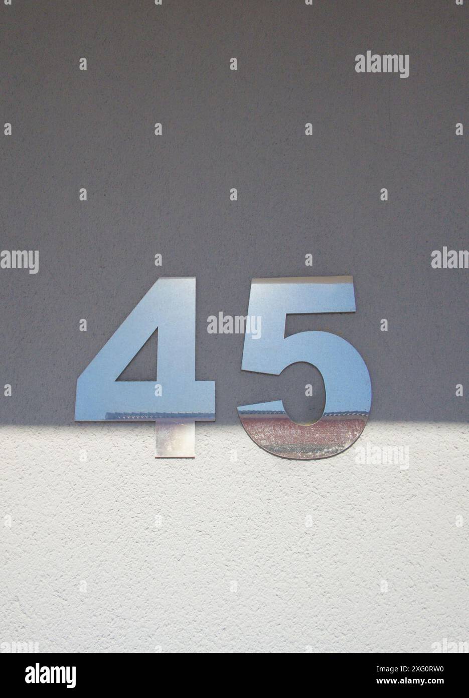 House number 45. Silver over grey wall Stock Photo - Alamy