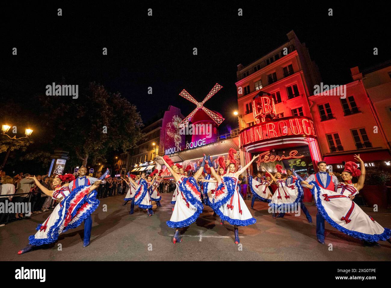 Dancers perform in front of the Moulin Rouge cabaret during the ...