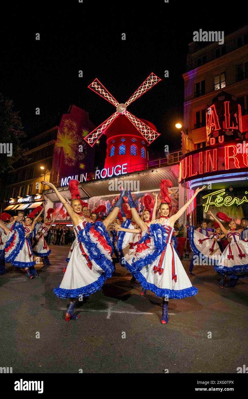 Dancers perform in front of the Moulin Rouge cabaret during the ...