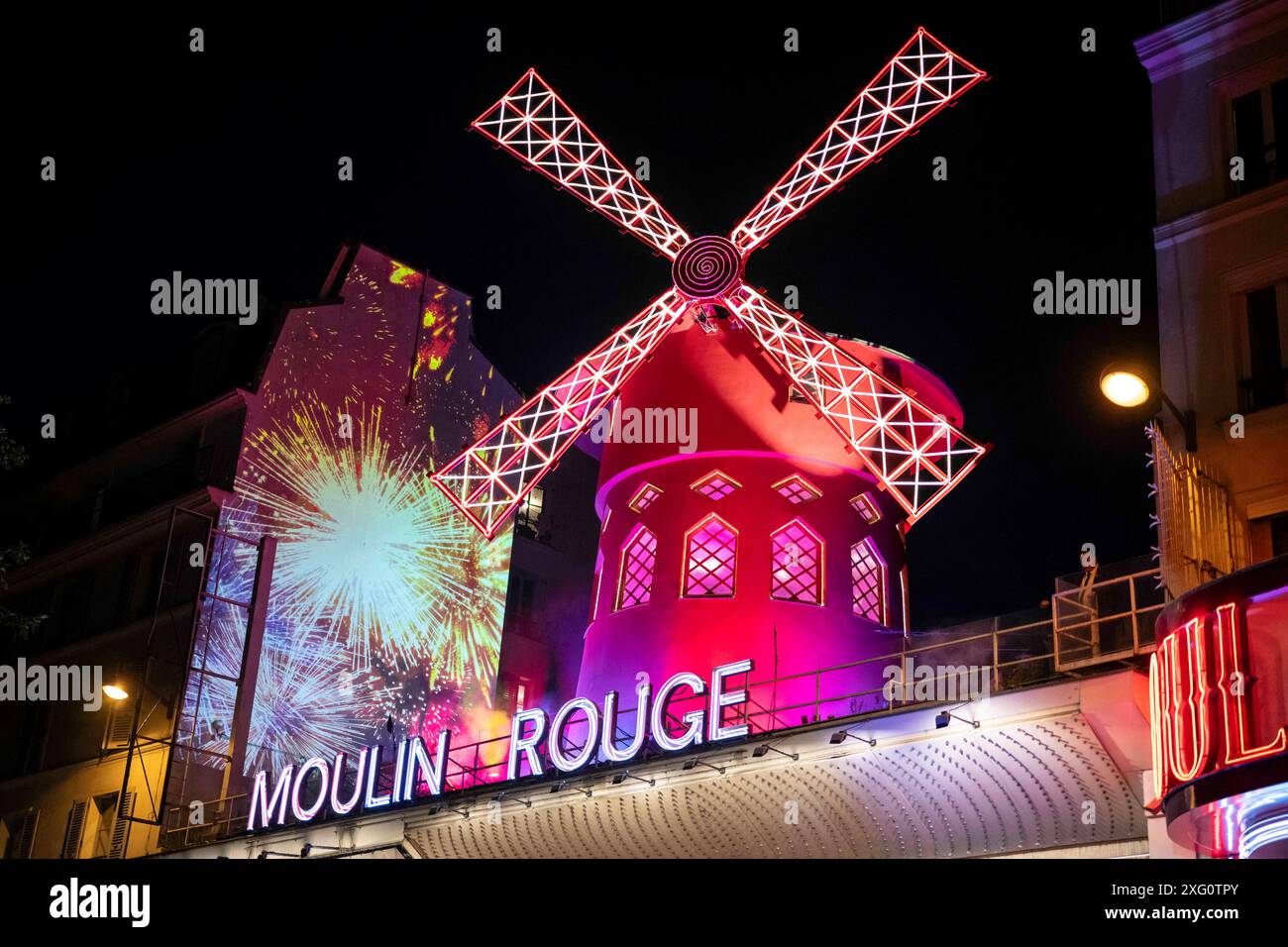 Dancers perform in front of the Moulin Rouge cabaret during the ...