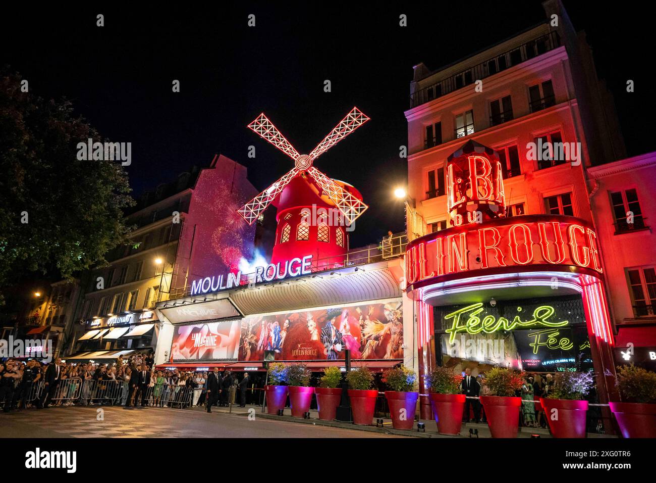 Dancers perform in front of the Moulin Rouge cabaret during the ...