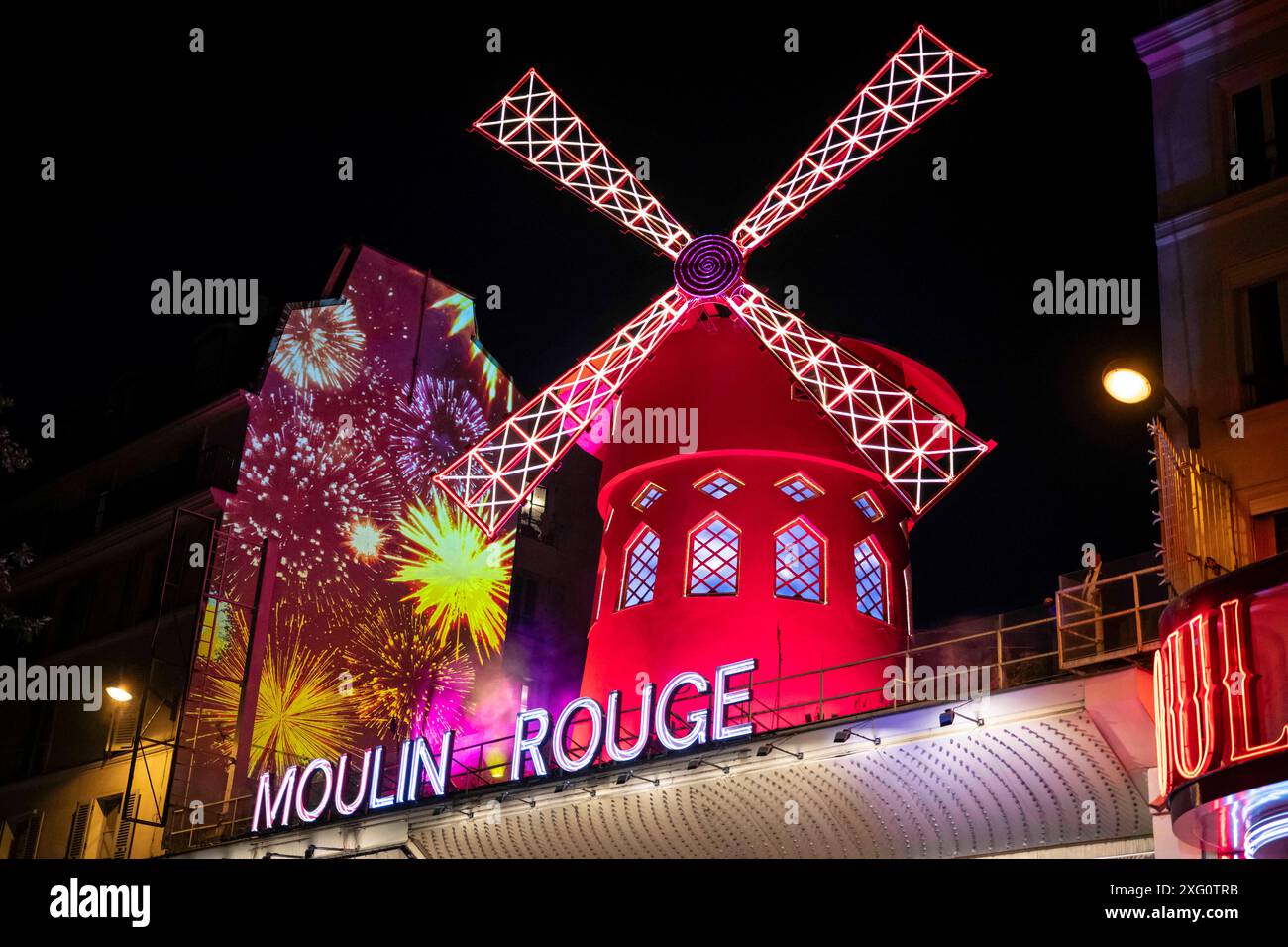 Dancers perform in front of the Moulin Rouge cabaret during the ...