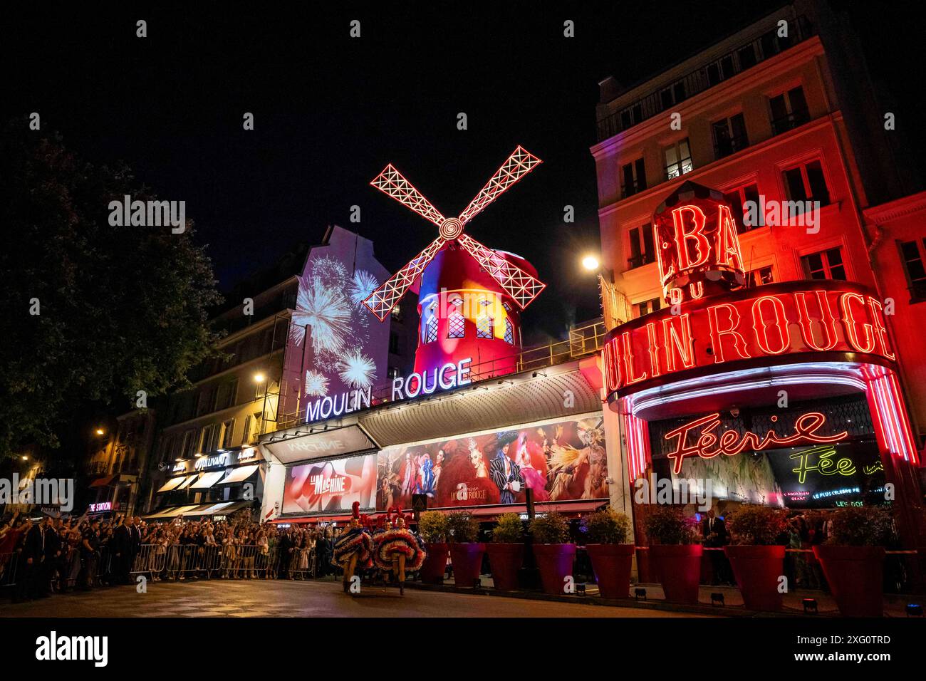 Dancers perform in front of the Moulin Rouge cabaret during the ...
