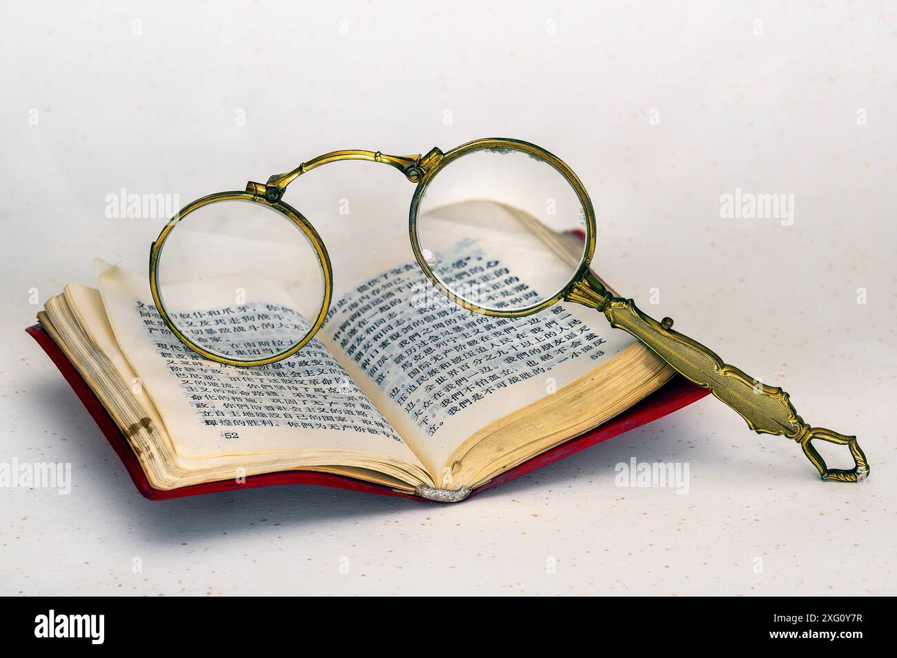 Antique lorgnette or lorgnette on Mao Bible Stock Photo - Alamy
