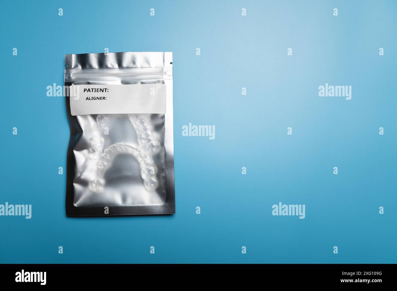 Silver plastic package body with transparent braces inside on a blue ...