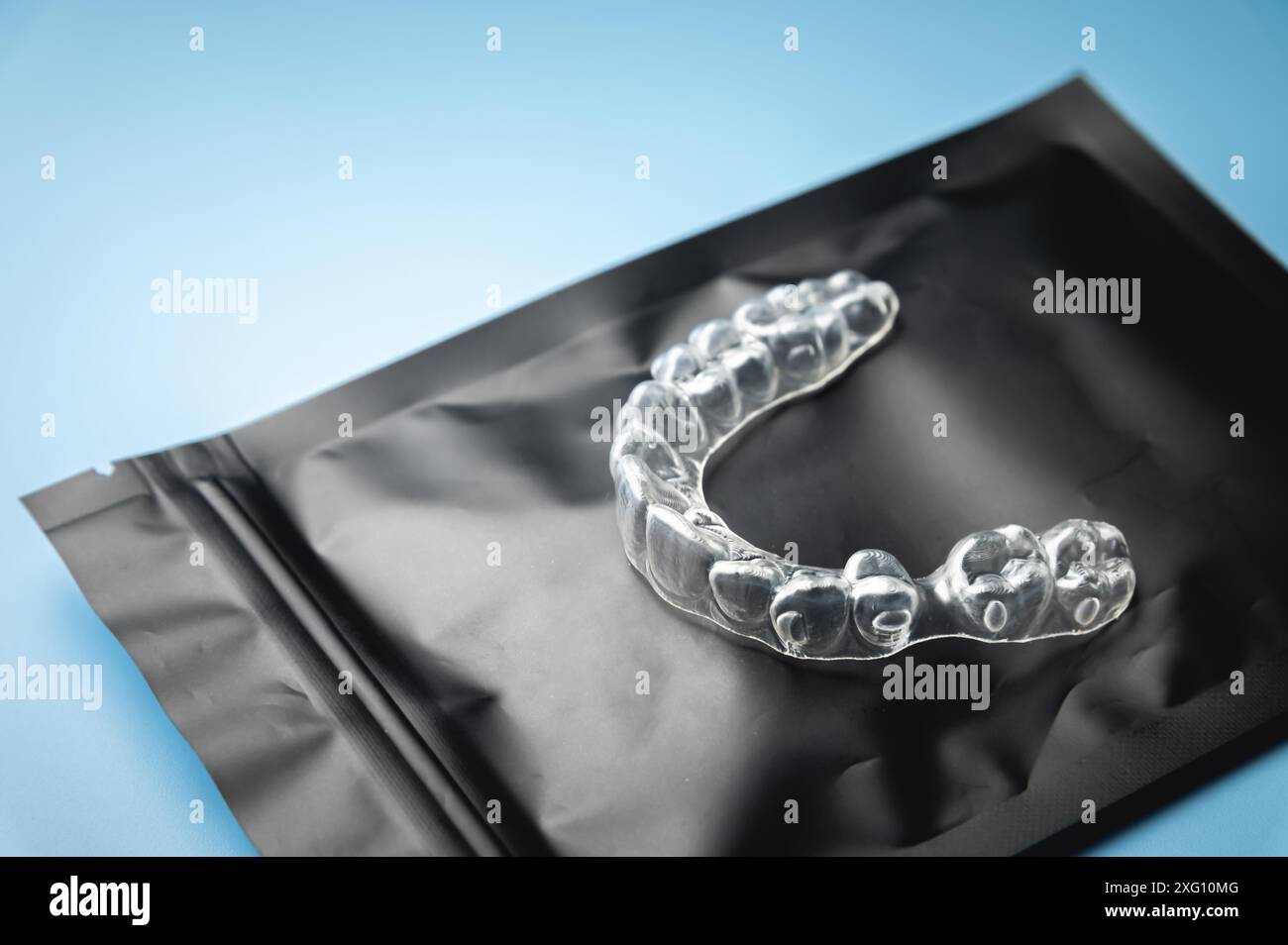 Close-up, invisible plastic braces on a black special zip package ...