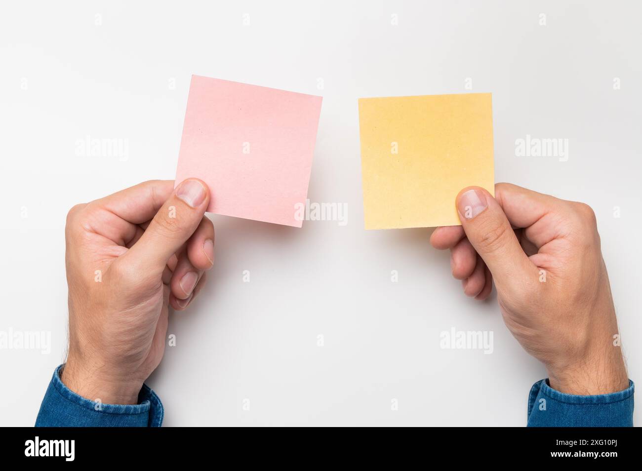 Hands of an office worker hold colored stickers for notes on a white ...