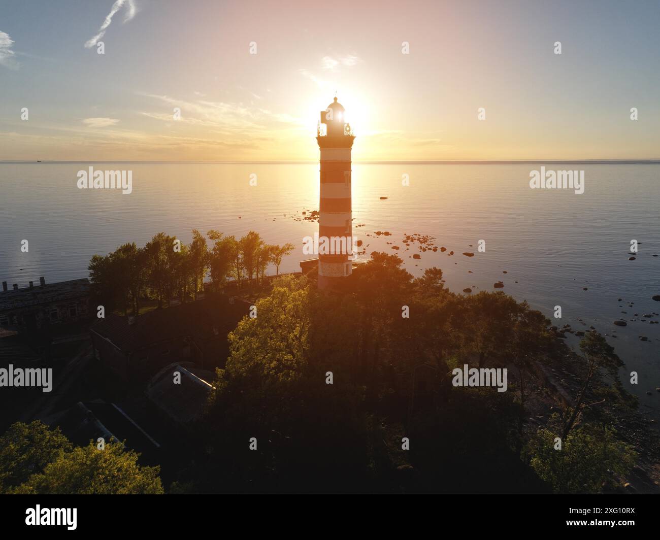Aerial view of lighthouse by the sea from drone, red striped landmark ...