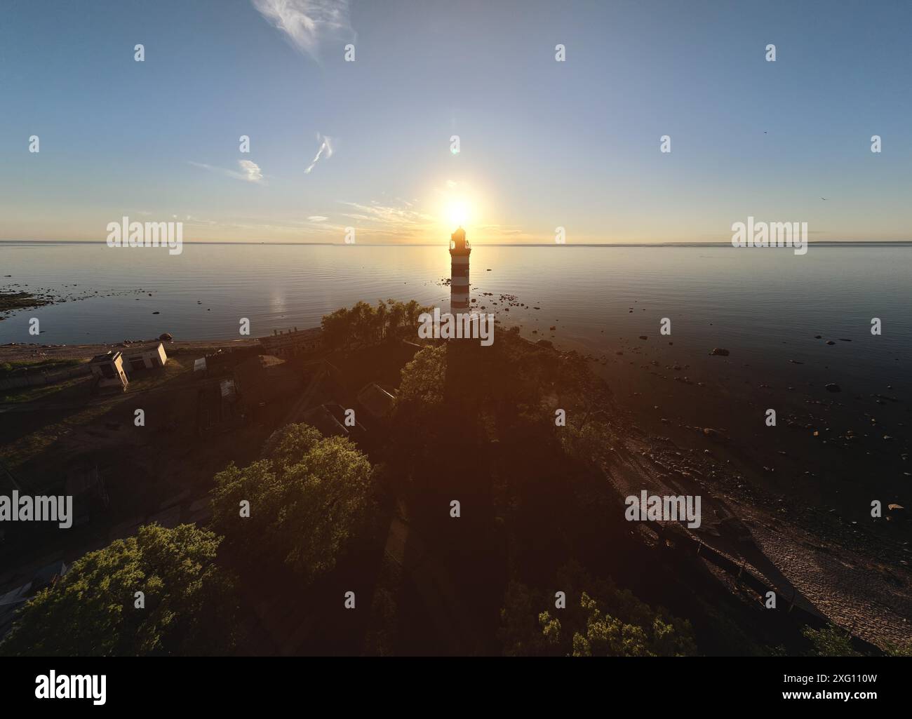Aerial view of lighthouse by the sea from drone, red striped landmark ...
