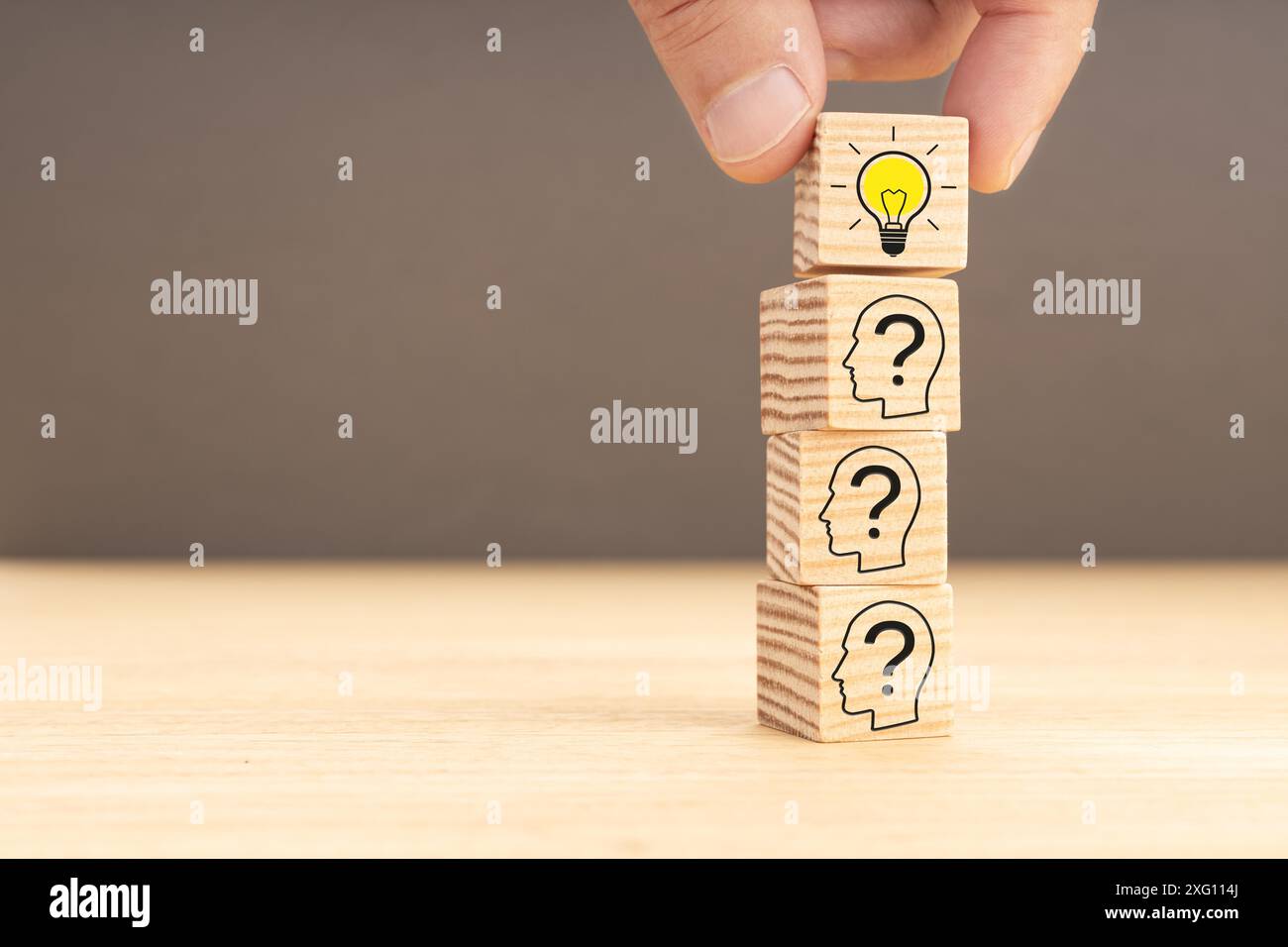 Creative idea and innovation concept. hand picking a wooden block with light bulb icon and human ...