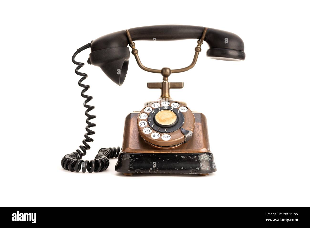 Old copper telephone with bakelite handset isolated on white background ...
