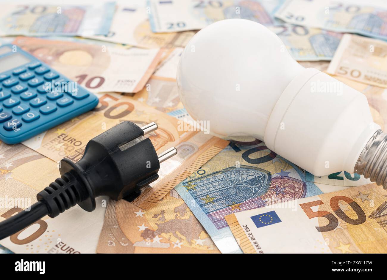 Energy prices cost on Europe concept. Light bulb, electrical plug, euro ...