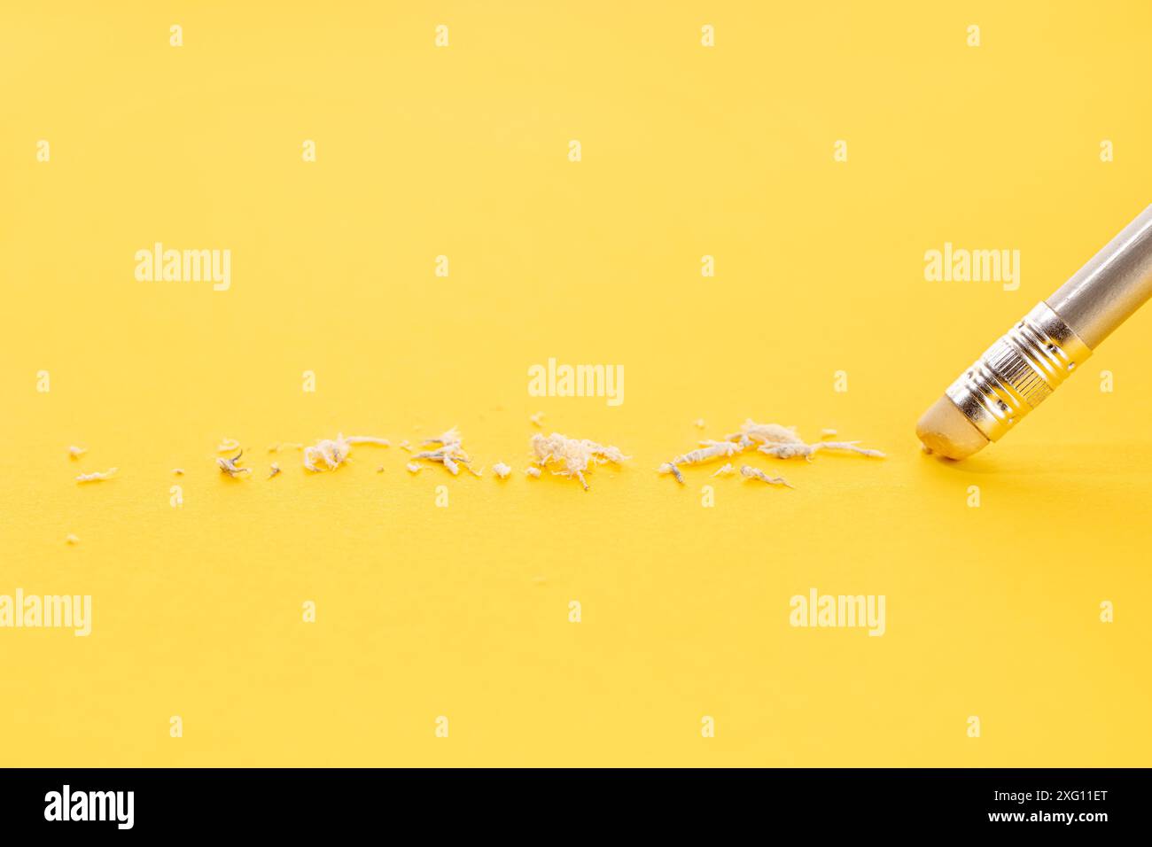 Pencil eraser working on yellow paper background. Mistake, erasing or ...