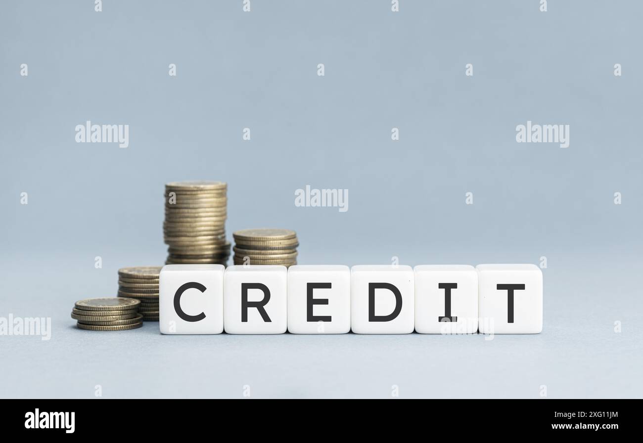 Credit word on block shape and coins stacked. Copy space Stock Photo ...