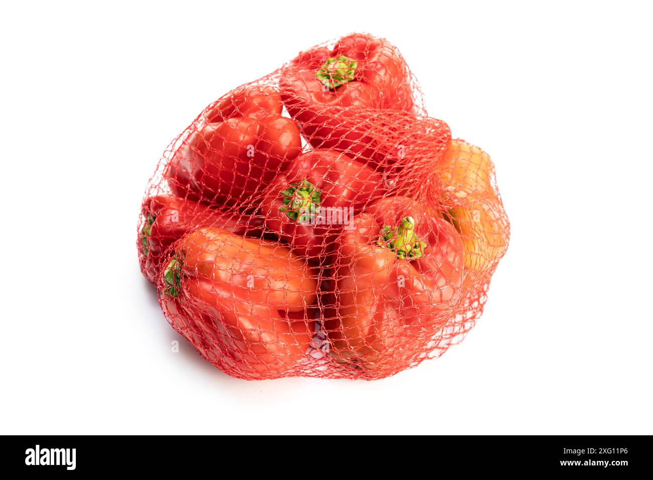 Red pepper on net bag isolated on white background. Food packaging ...