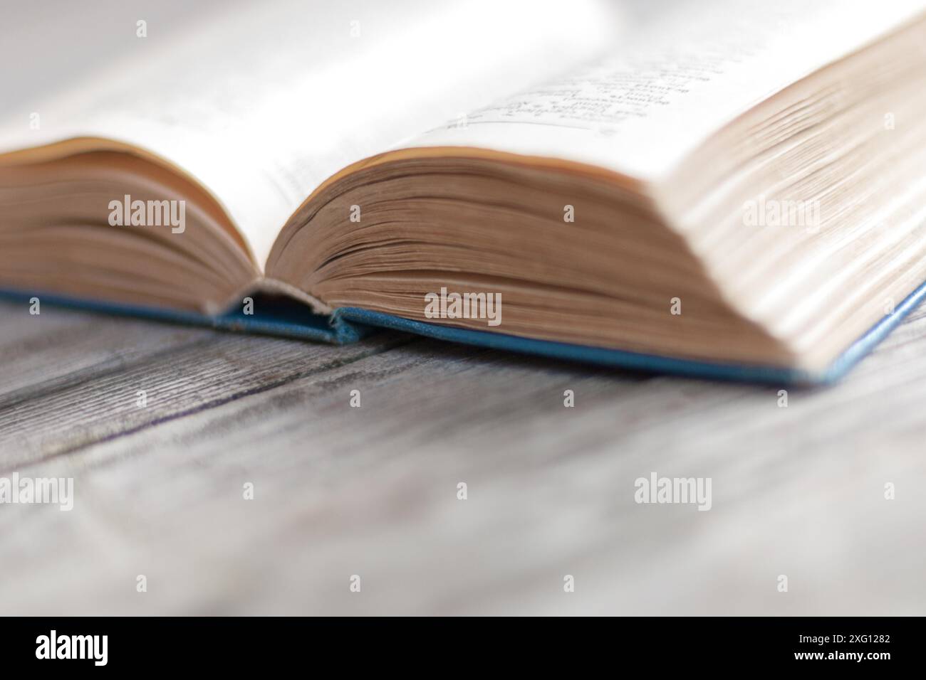 Open old-fashioned paper book backlit with daylight Stock Photo - Alamy
