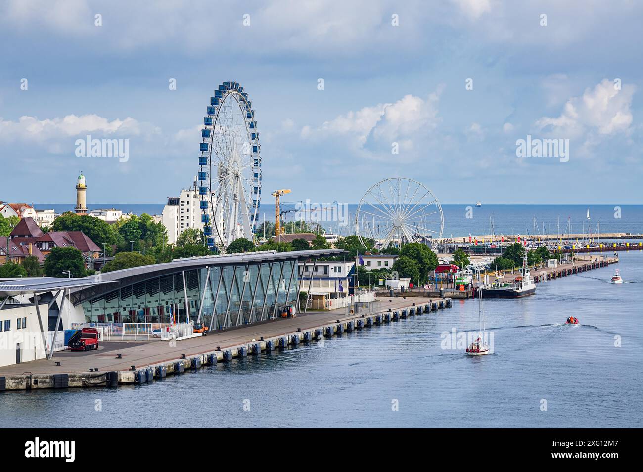 Ferris wheel and lighthouse on the Baltic coast in Warnemuende Stock ...