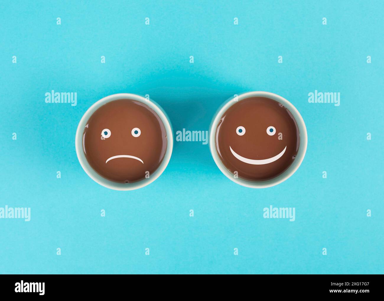 Cup of coffee with a sad and a happy face, positive and negative ...