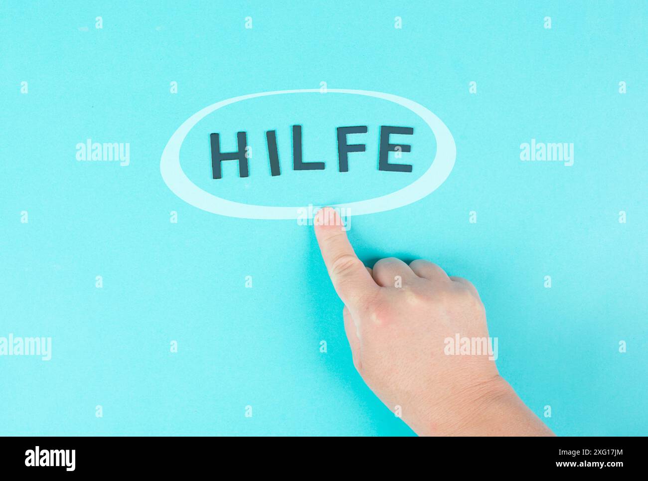 Pointing to the word help with the finger, german language, giving ...