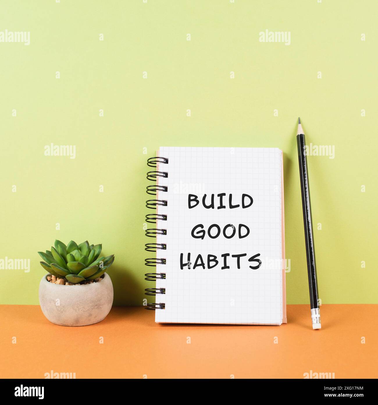 The words build good habits are standing on a notebook, change ...