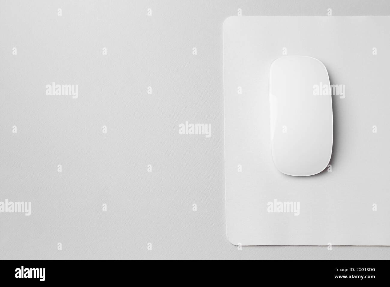 One wireless mouse with mousepad on grey background, top view. Space ...