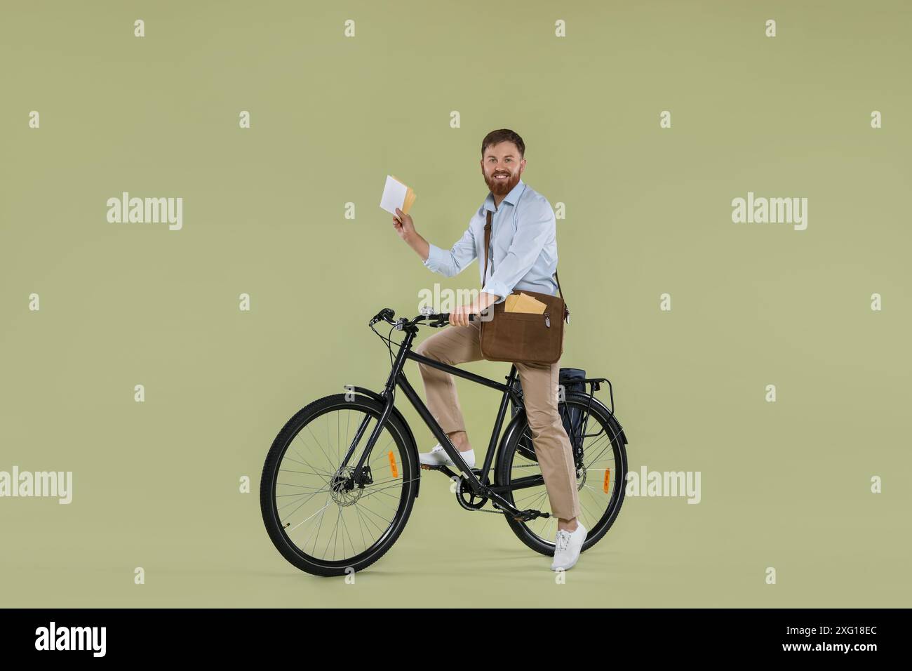 Postman on bicycle delivering letters against light green background ...