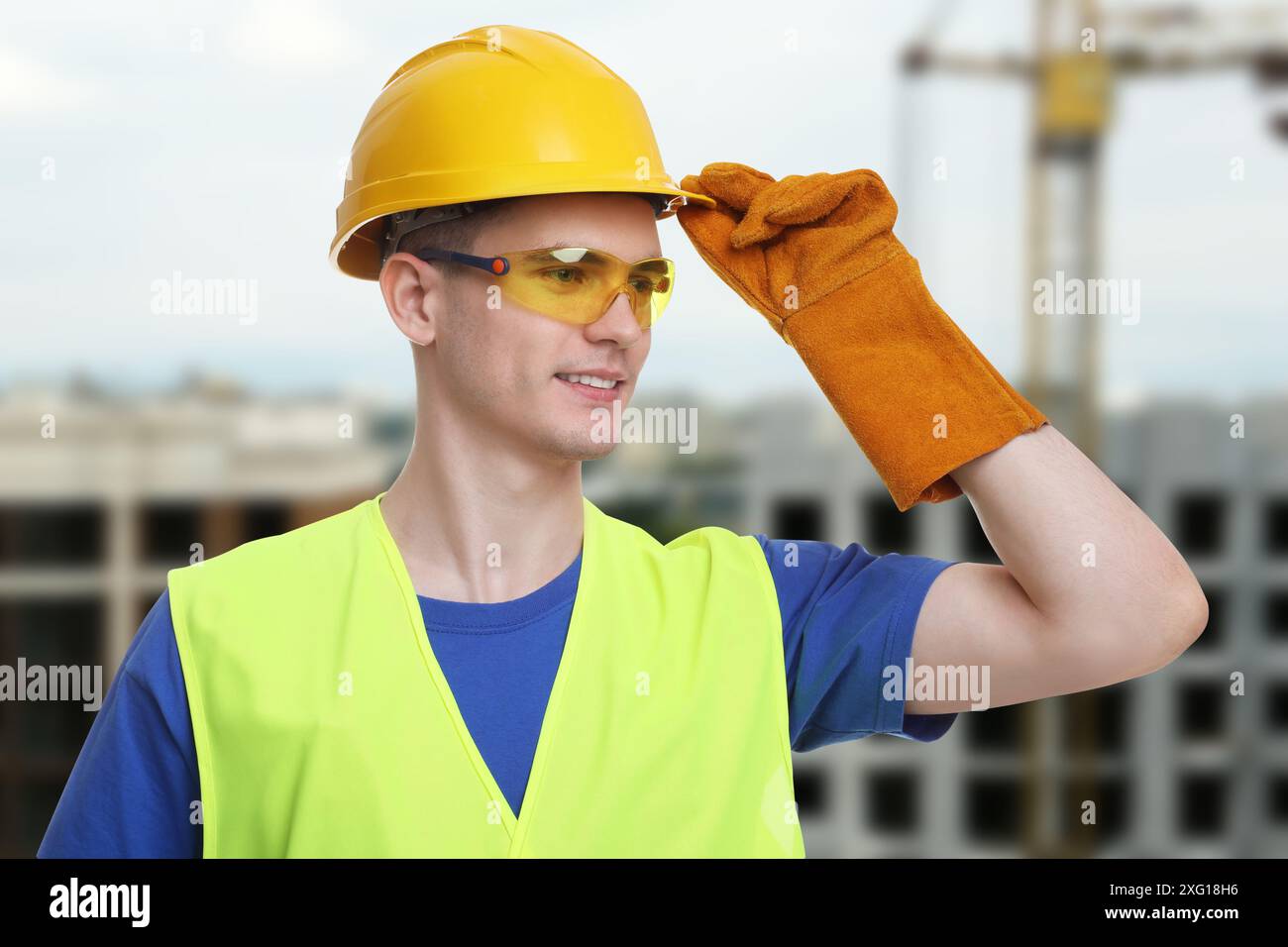 Young man wearing safety equipment at construction site Stock Photo - Alamy