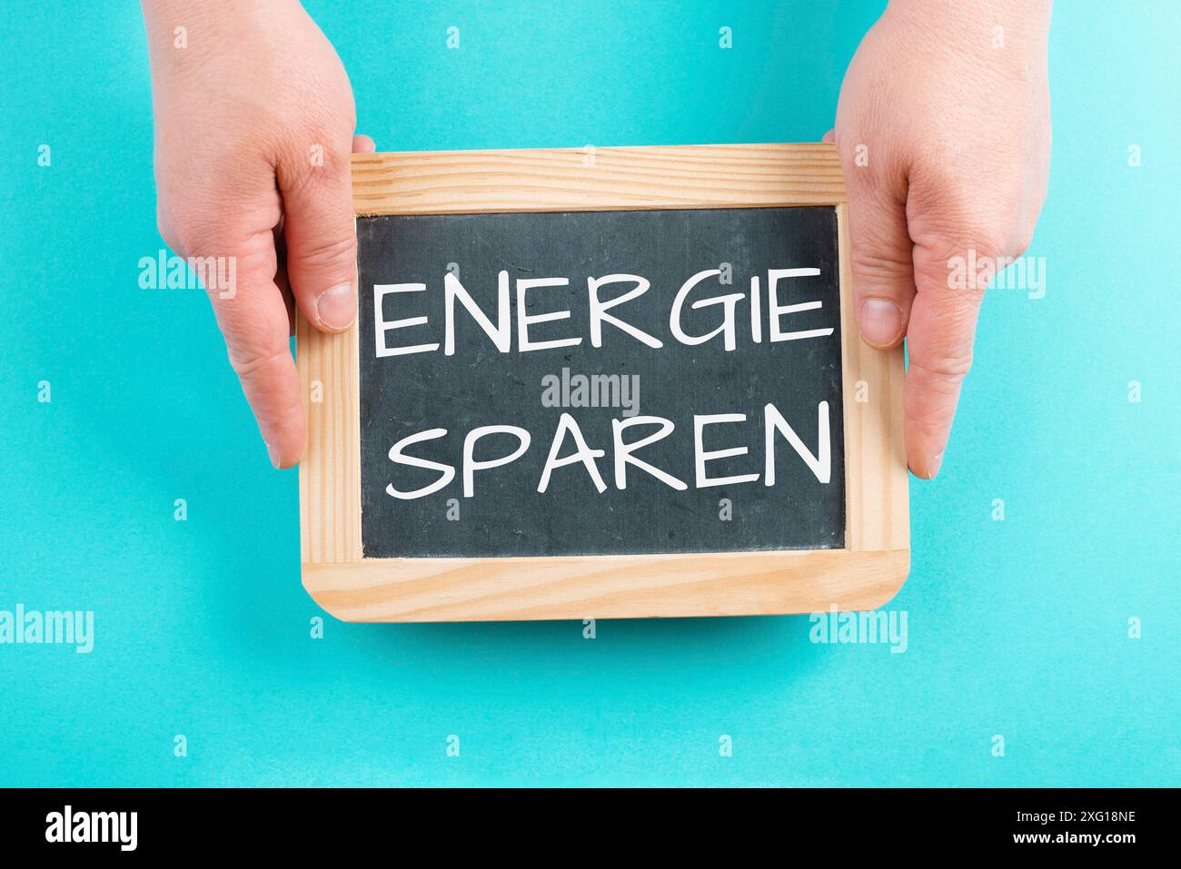 Save energy is standing in german language on the chalkboard, increase ...