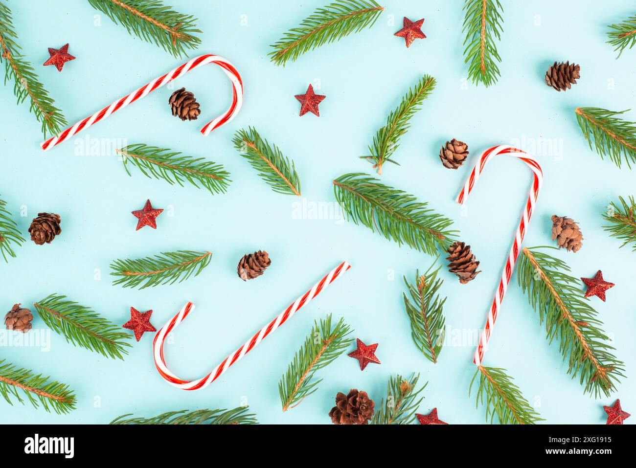 Christmas holiday background with candy cane, fir branches, pine cones and red stars, winter ...