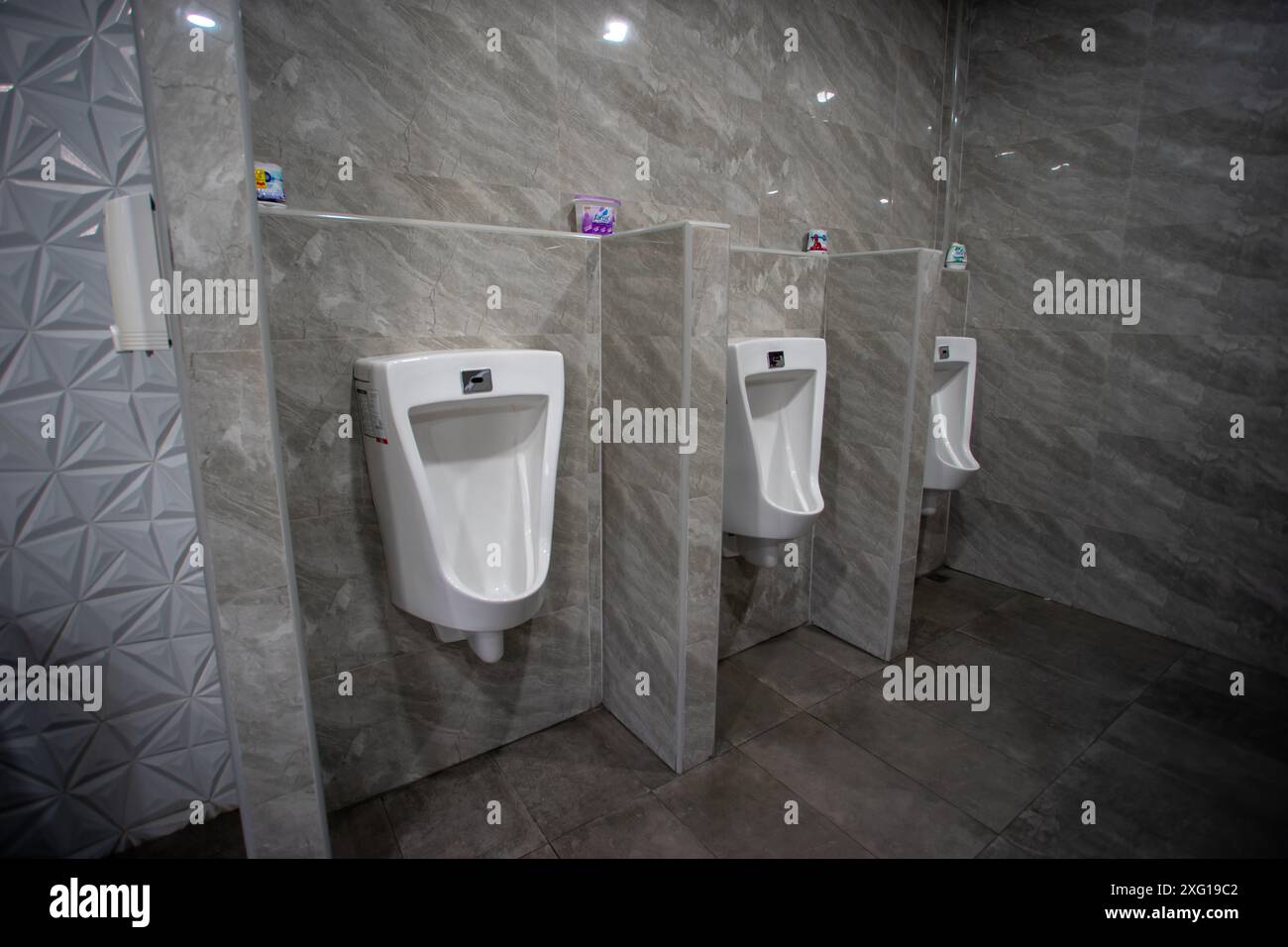 White urinals in the men's bathroom with tiled wall Stock Photo - Alamy
