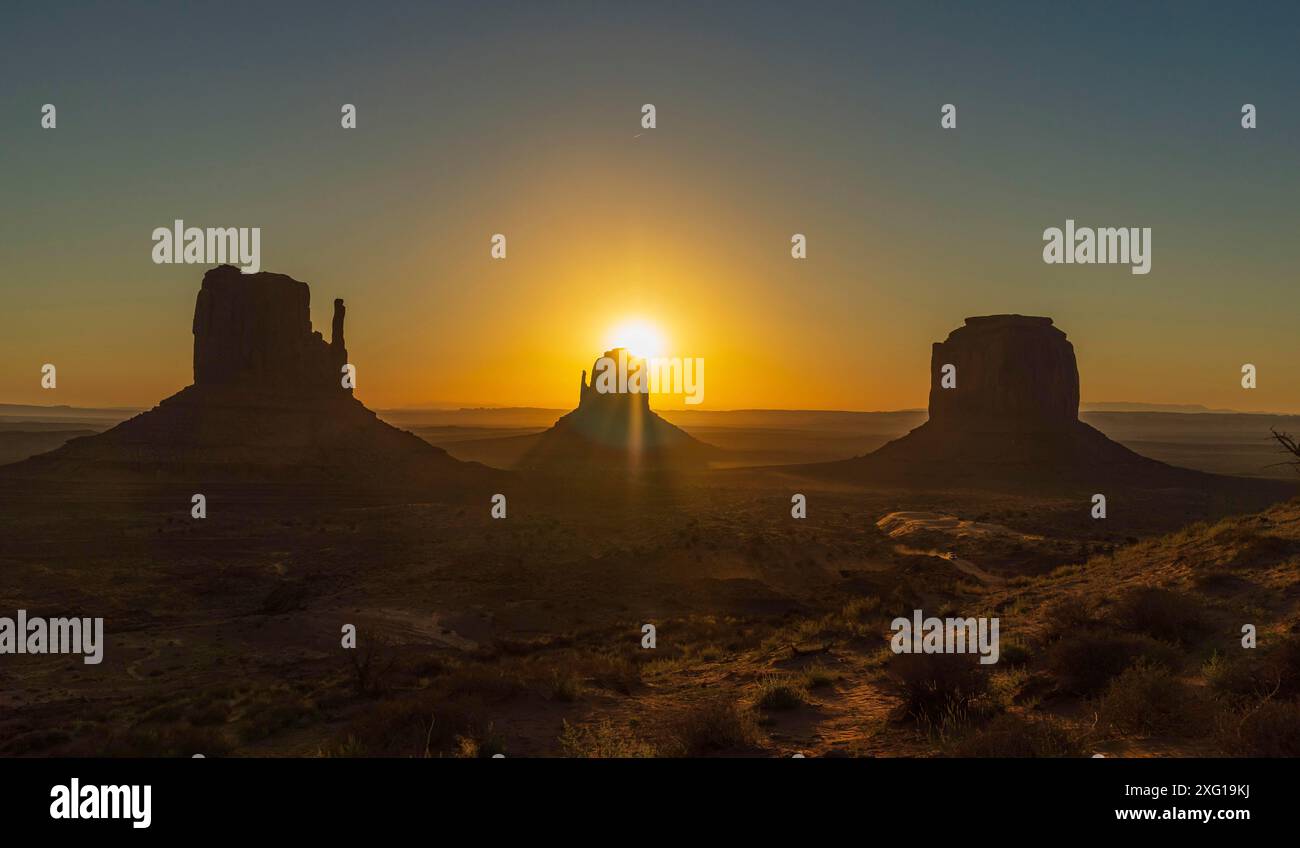 Sun rising behind a butte at Monument Valley, Navajo Nation Stock Photo ...