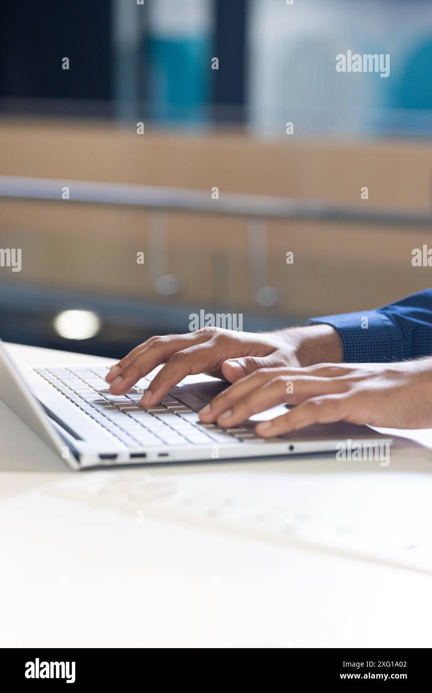 Typing on laptop, business professional working on project in office ...