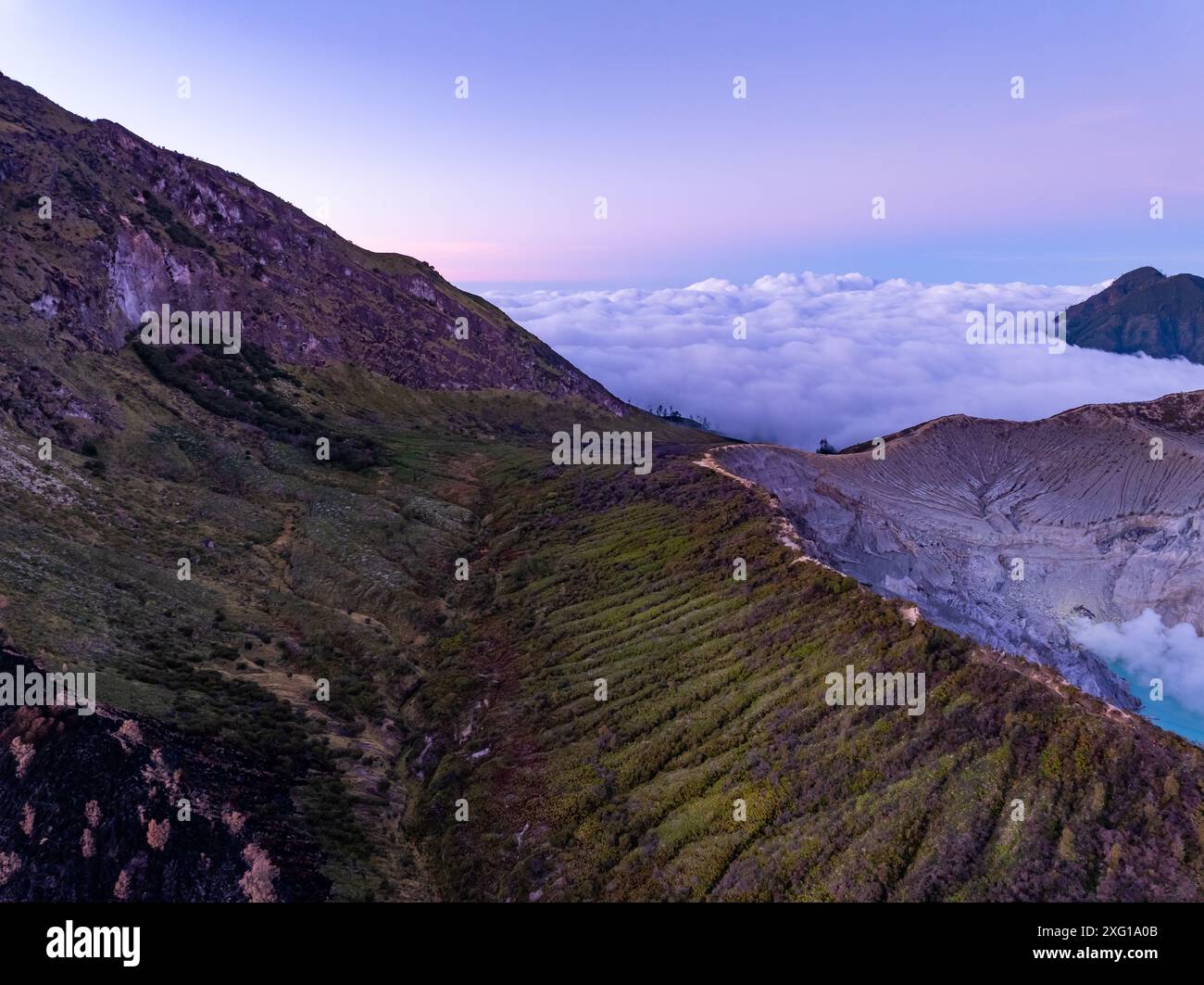 Aerial view Kawah Ijen volcano with turquoise sulfur water lake at sunrise.Amazing nature ...