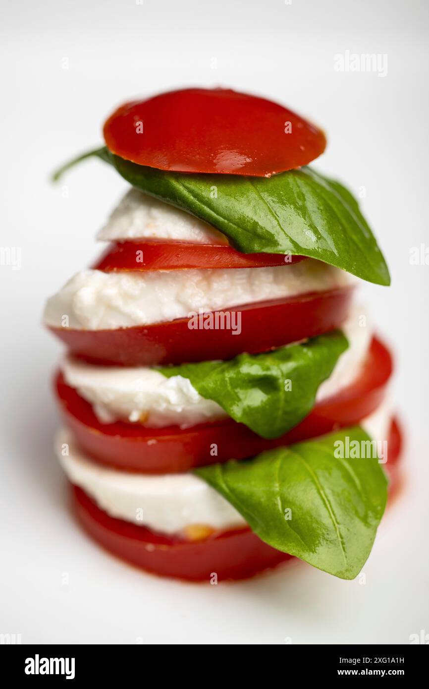 Stacked insalada caprese on white Stock Photo - Alamy