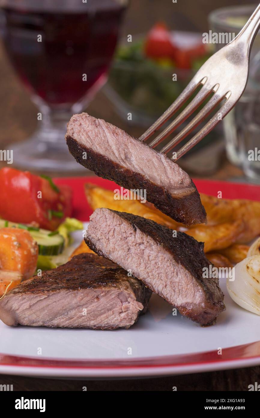 Steak on a fork Stock Photo - Alamy