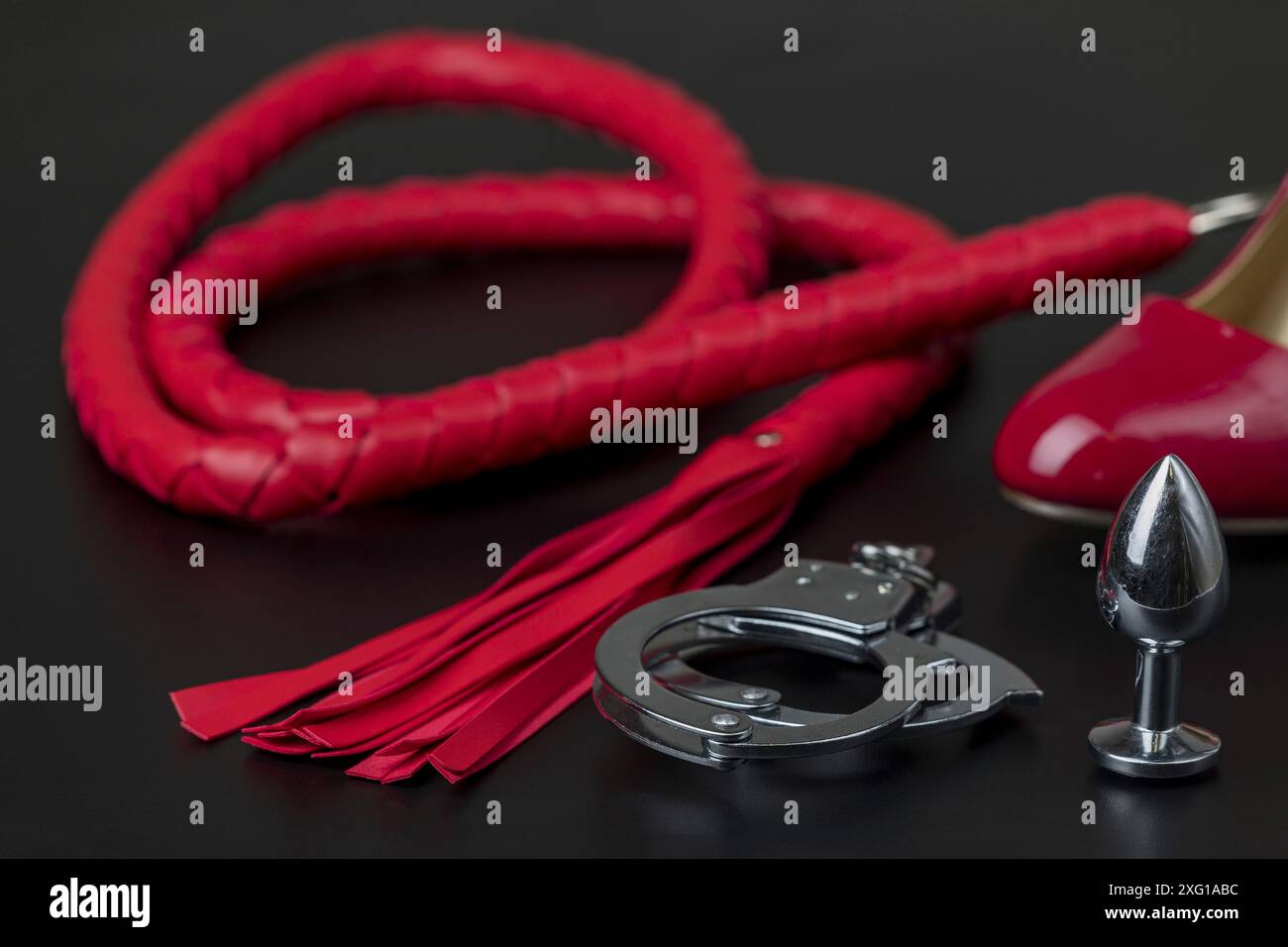 Red whip and a high heel Stock Photo - Alamy
